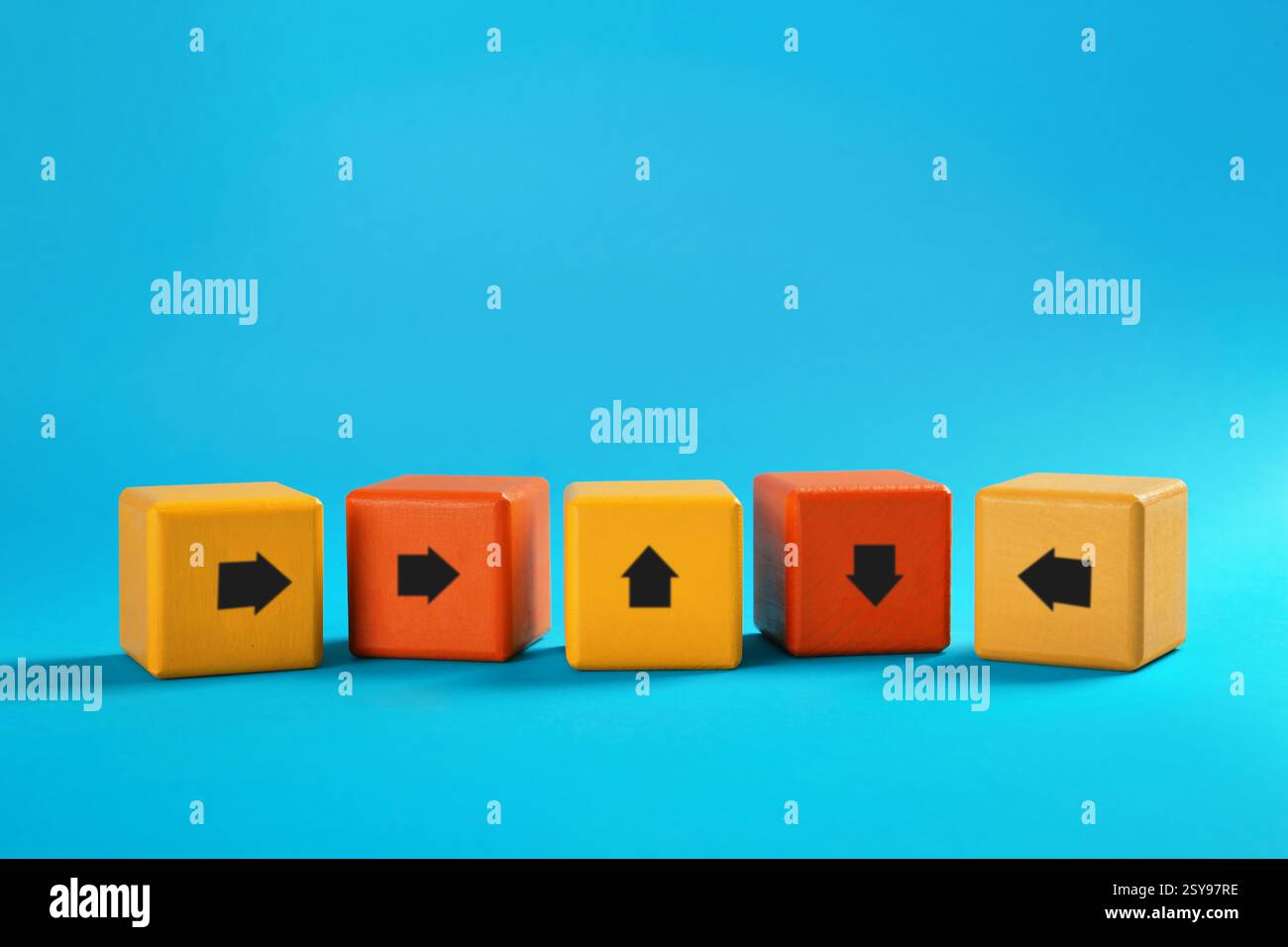 Colorful cubes with arrows pointing in different directions on light ...