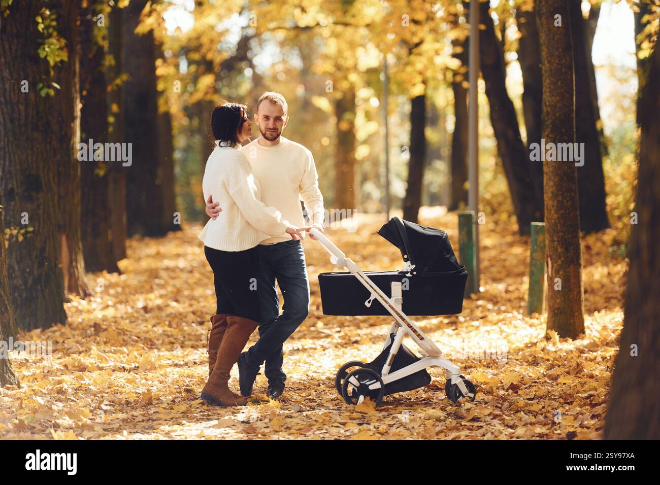 Beautiful parents is in the forest with pram having a walk Stock Photo ...