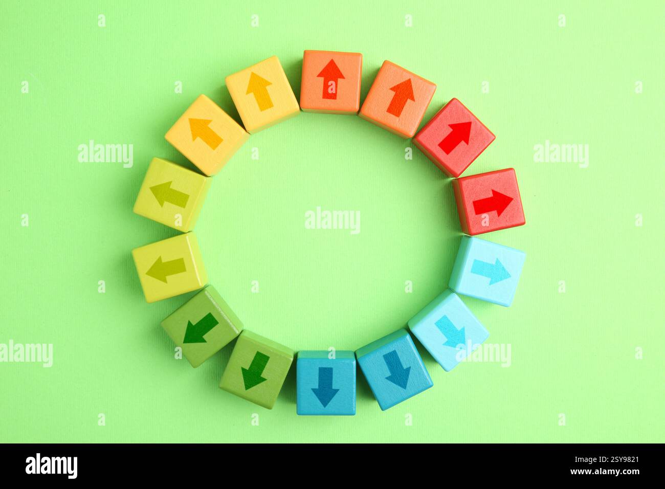Round frame of colorful cubes with arrows on light green background ...