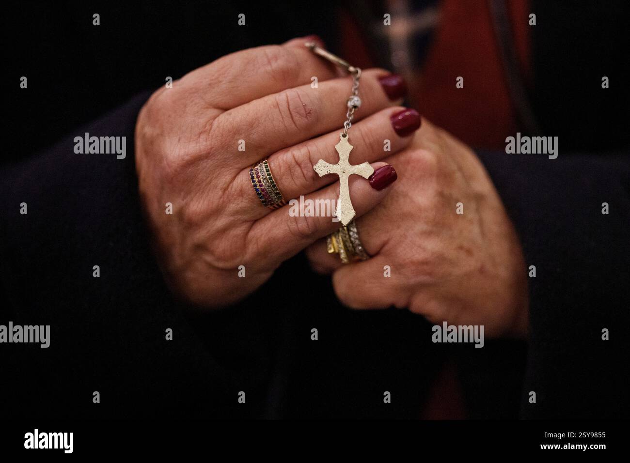 A woman prays for Pope Francis at Almudena Cathedral in Madrid, Spain ...