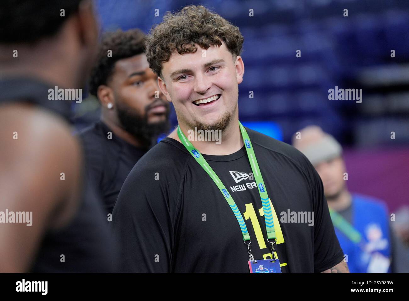 Michigan defensive lineman Mason Graham chats with others as he waits ...