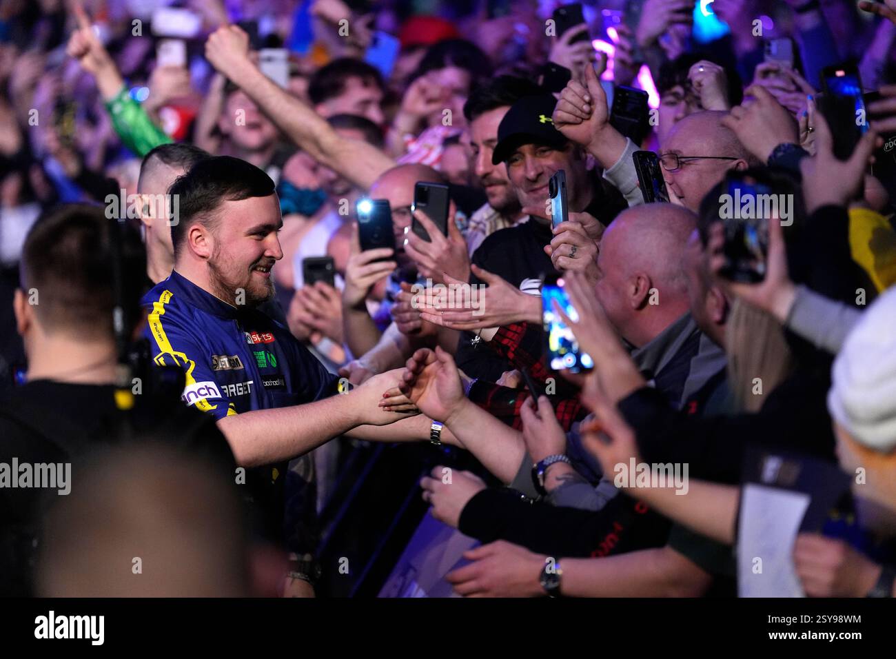 Luke Littler walks to the oche during night four of the BetMGM Premier ...
