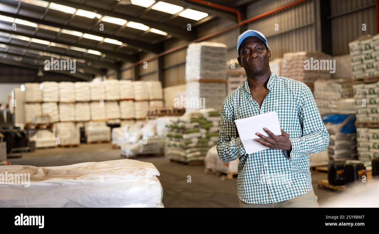 Portrait of focused African-American man checking order list Stock ...