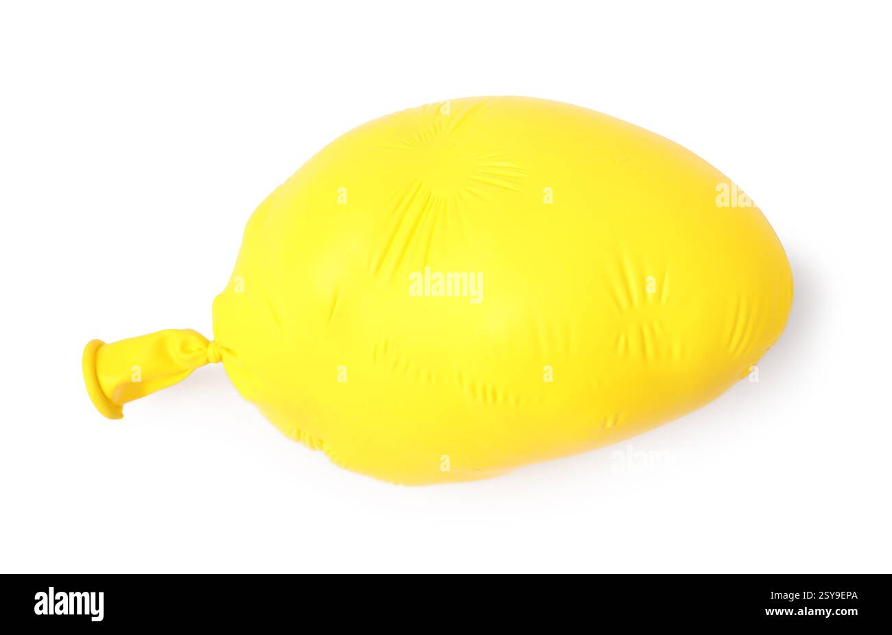 One yellow half deflated balloon isolated on white, top view Stock ...