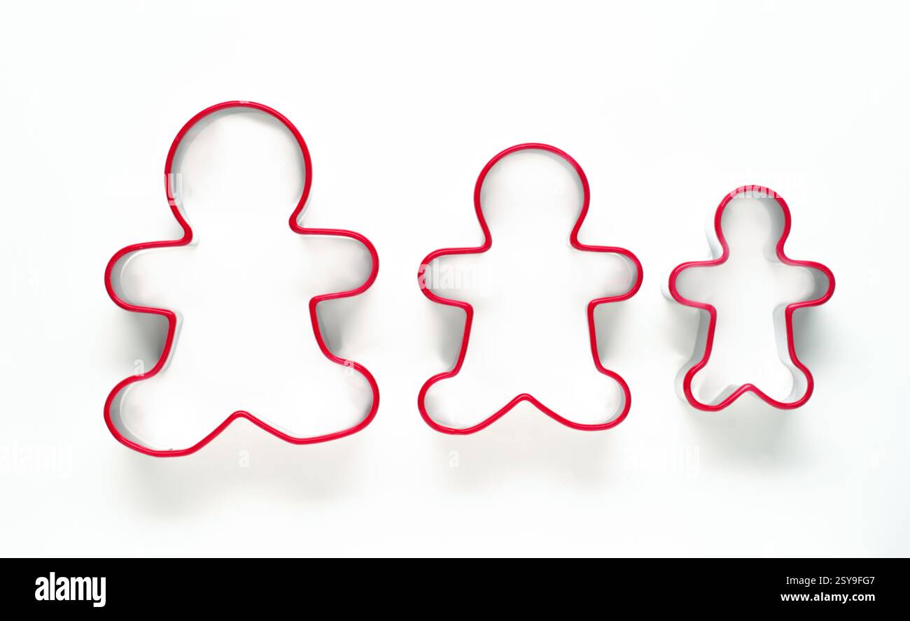 Three red and white metal gingerbread man cookie cutters of different ...