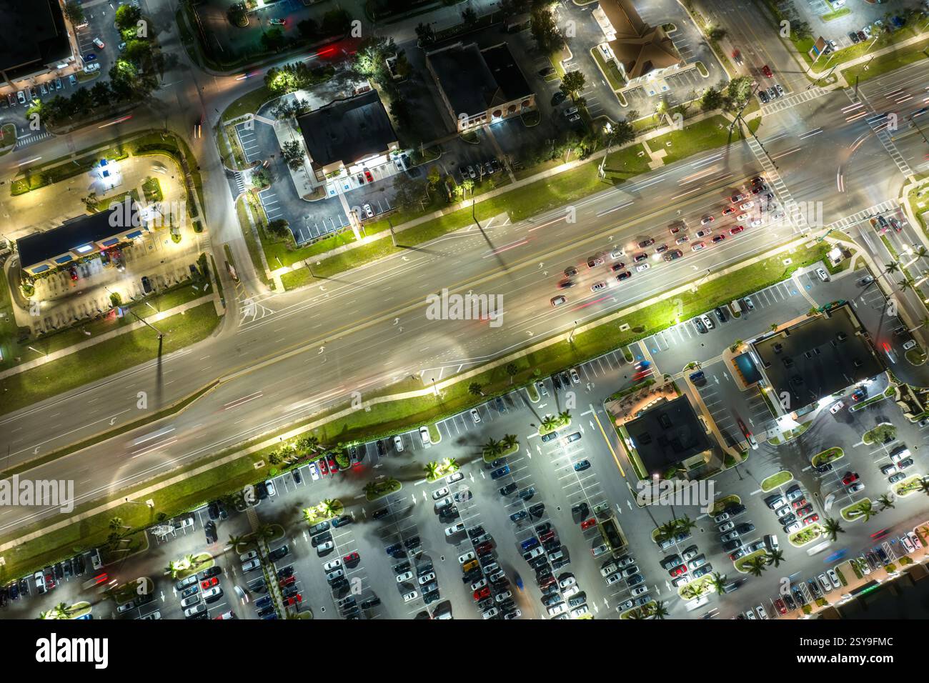 Aerial view of shopping plaza stores and American wide highway with ...