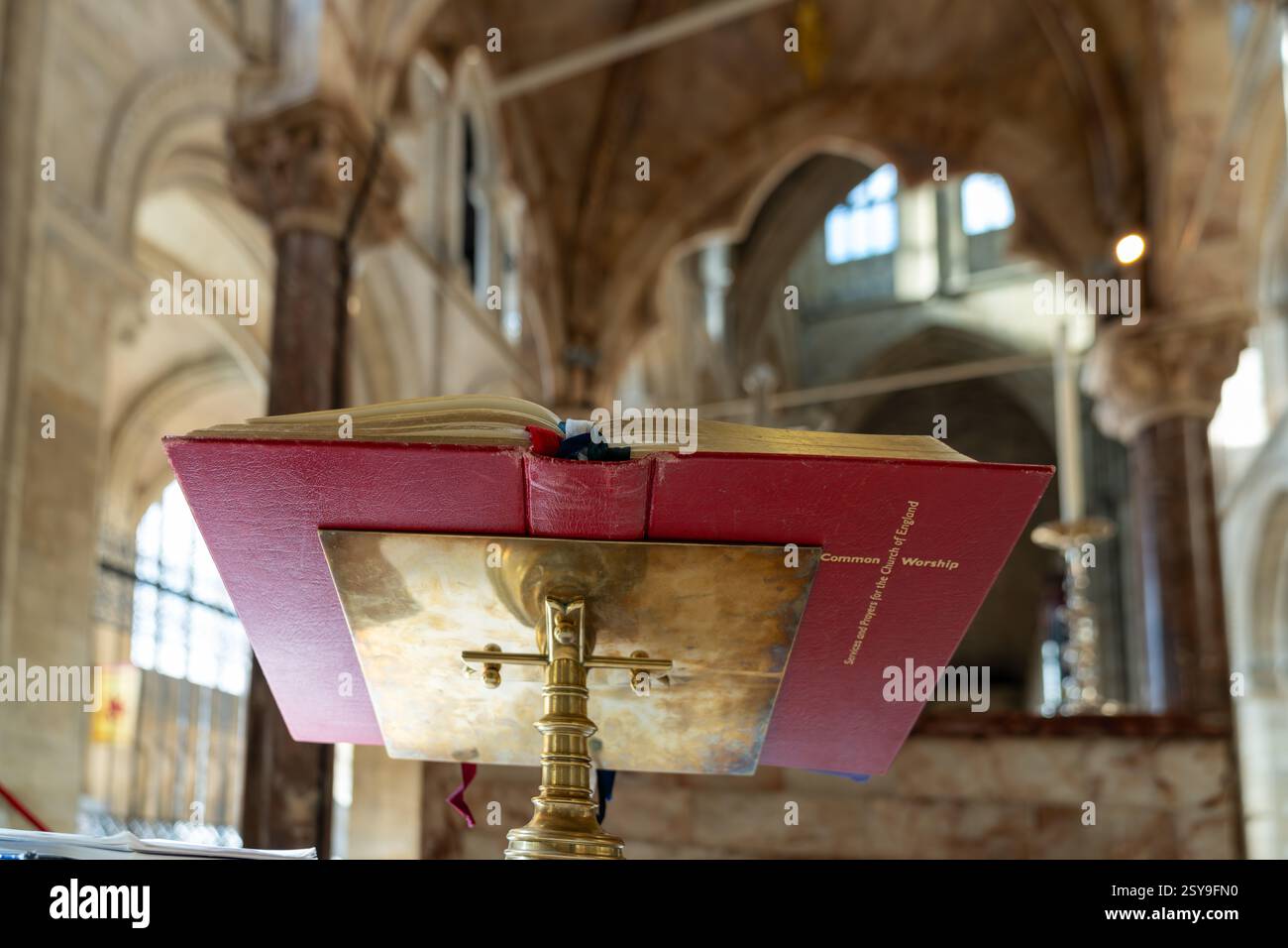 Open bible on a lectern in a church, with blurred background and soft ...