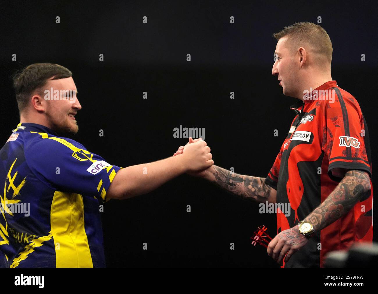 Luke Littler greets Nathan Aspinall ahead of their match during night ...