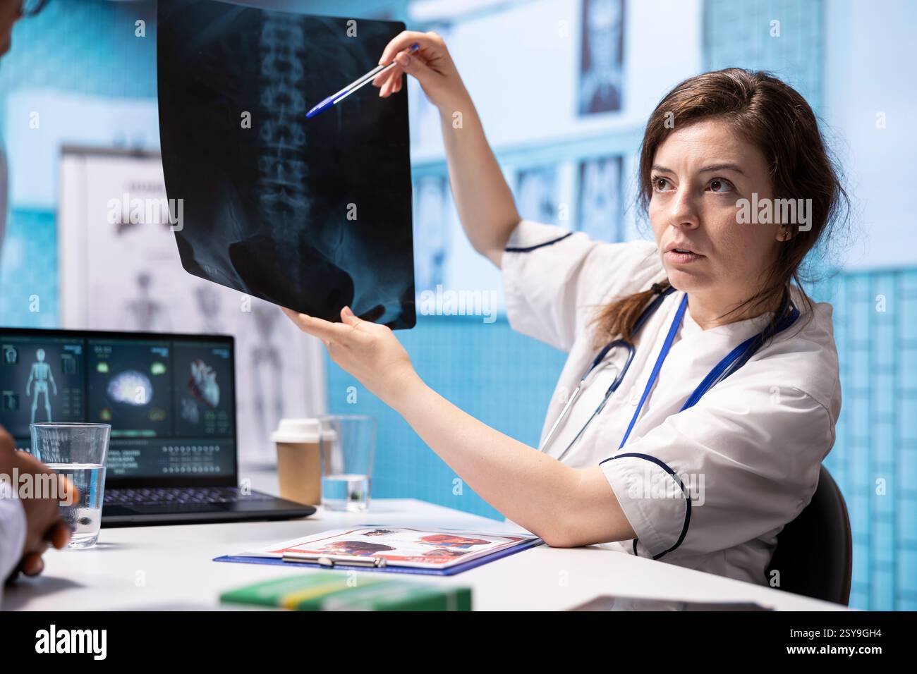 Professional medic presenting the diagnostics for male patient in office, discussing about ...