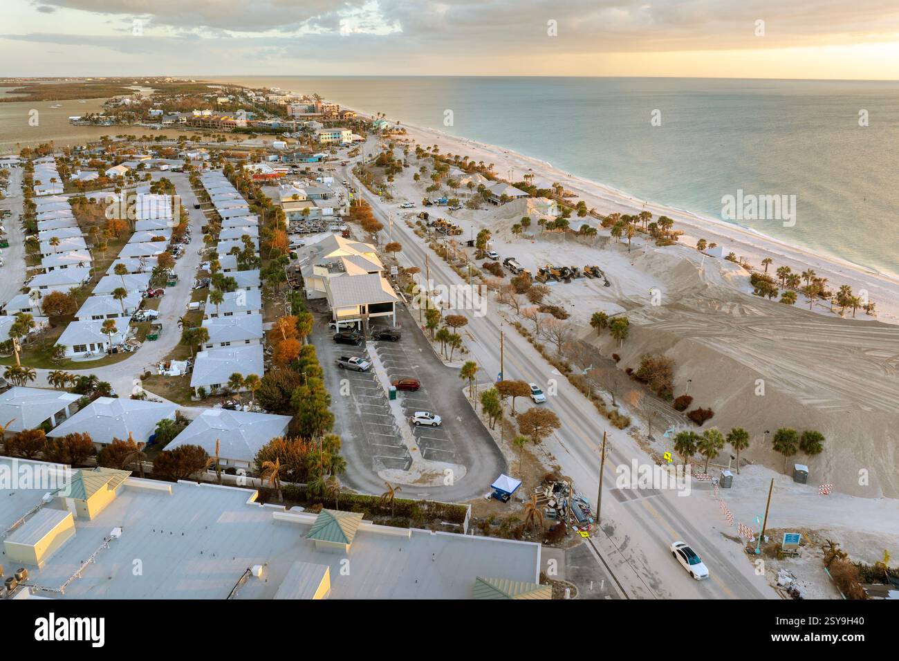 Hurricane aftermath cleanup. Piles of sand at sand recipient site on ...