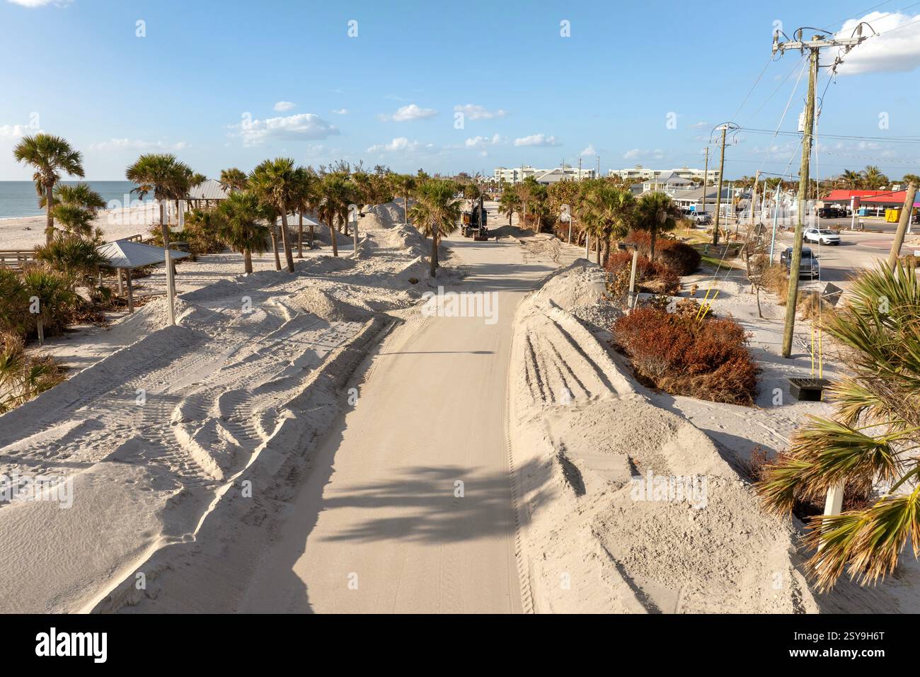 Hurricane Milton aftermath cleanup. Piles of debris and sand on street ...