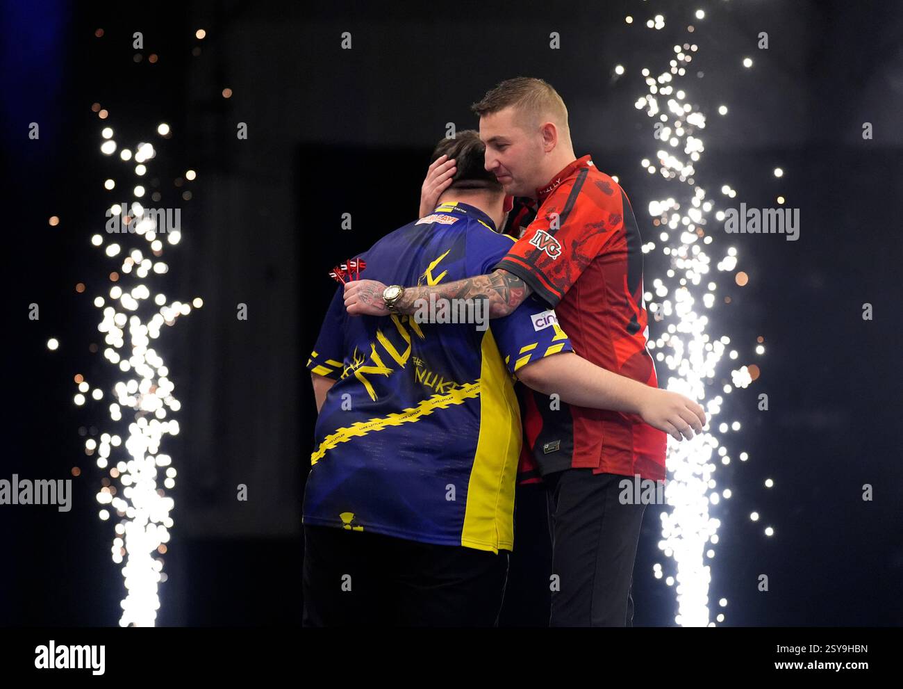 Luke Littler (left) celebrates victory against Nathan Aspinall during ...