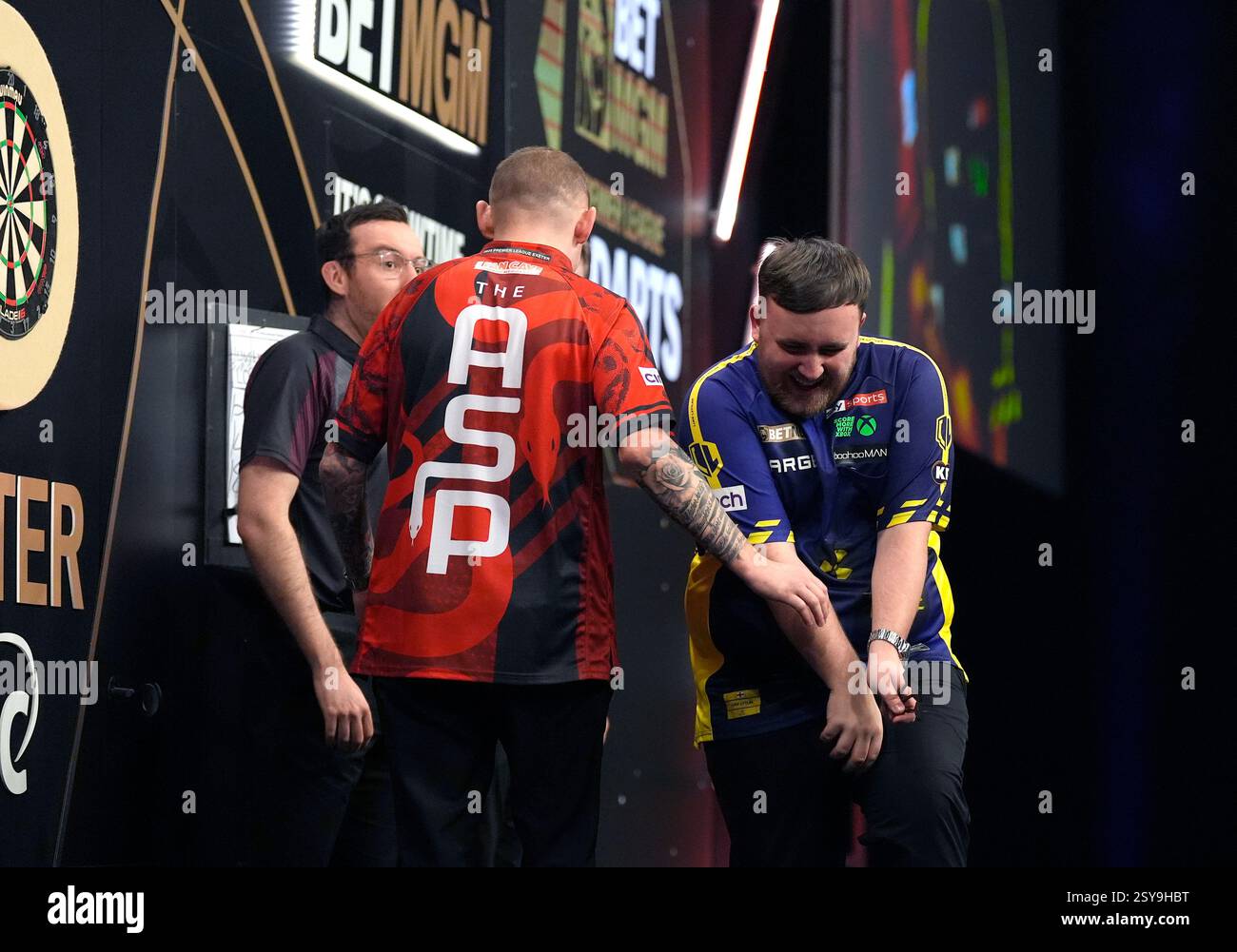 Luke Littler (right) celebrates victory against Nathan Aspinall during ...