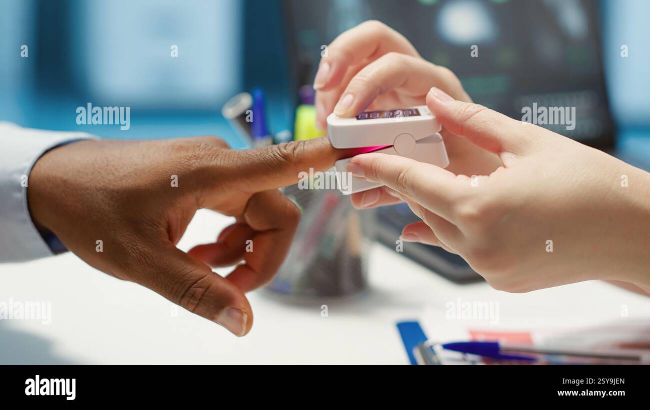Physician measuring the oxygen saturation and pulse rate using an ...
