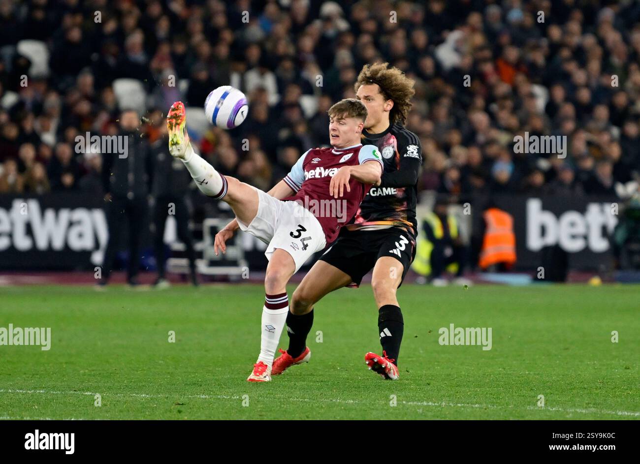 London, UK. 27th Feb, 2025. Evan Ferguson (West Ham) clears under ...