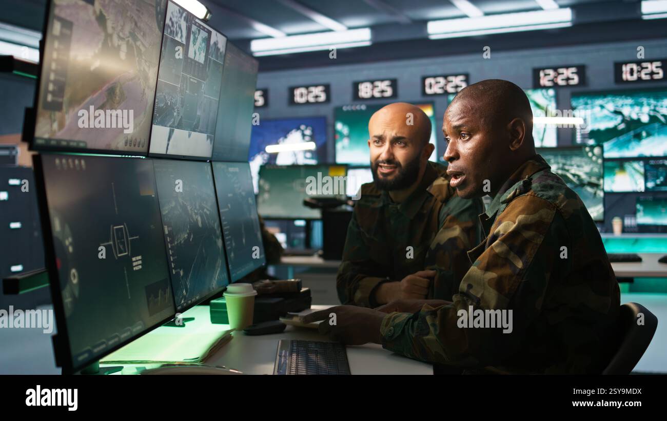 Army unit working in governmental facility next to coworker, doing brainstorming, operating ...