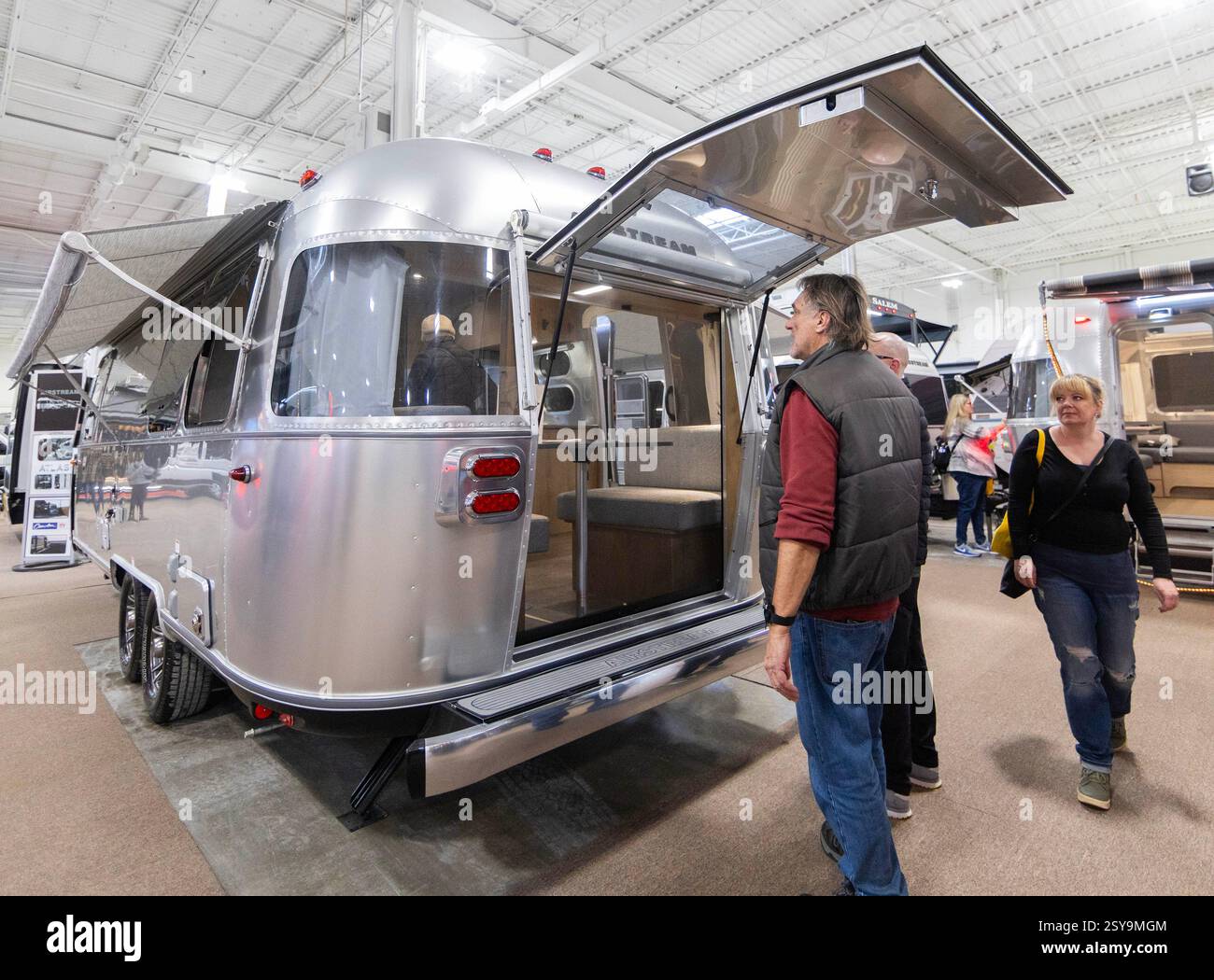 Mississauga, Canada. 27th Feb, 2025. People look at a travel trailer ...