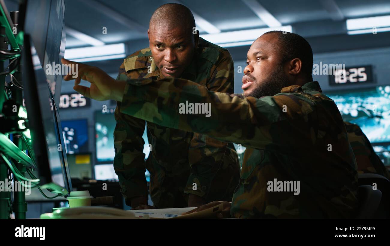Air force officer and colleague performing tactical level surveillance ...