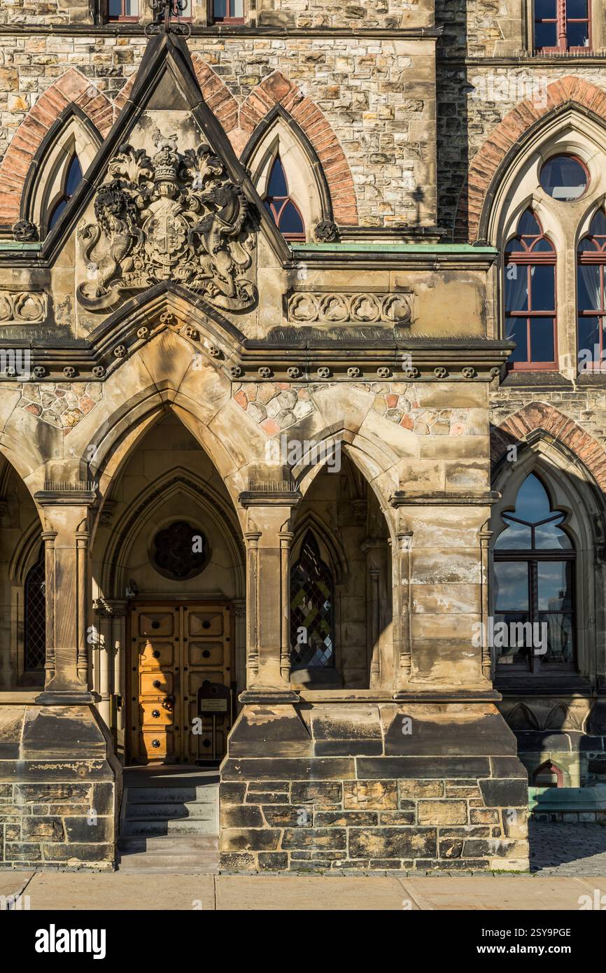 Building with a large archway and a door. The door is open and has a ...