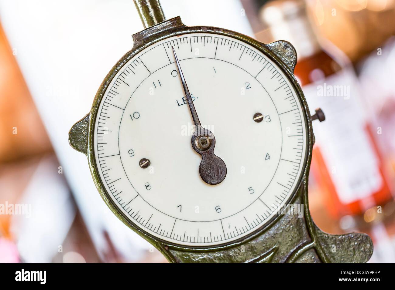 Small scale with a white face and black numbers. The numbers are 1 ...