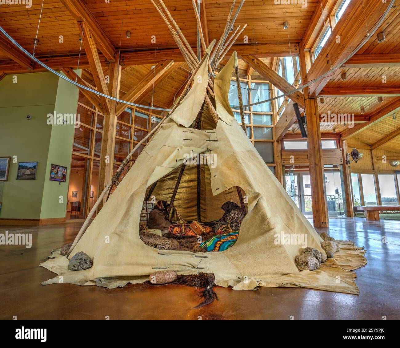 Teepee is inside a building. The teepee is made of canvas and has a ...