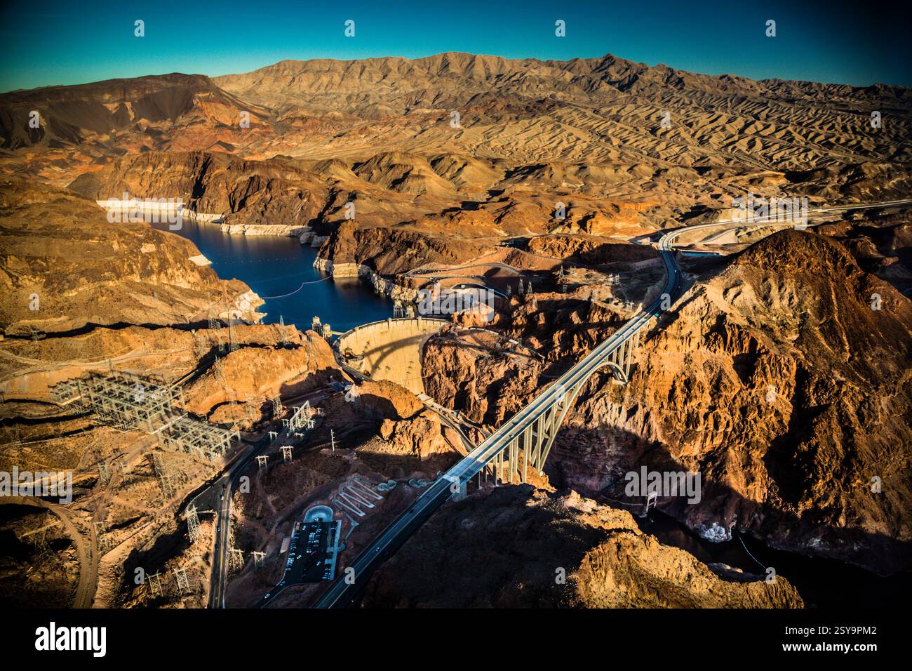 Bridge is seen over a river in the desert. The bridge is a large, long ...
