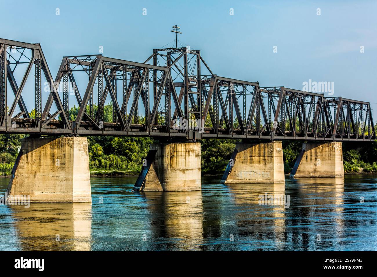 Bridge with four pillars and a cross on top. The bridge is over a river ...