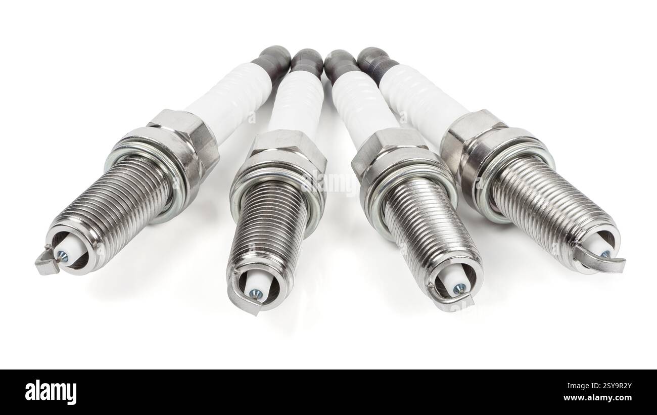 Four iridium spark plugs in a row isolated on white background with ...