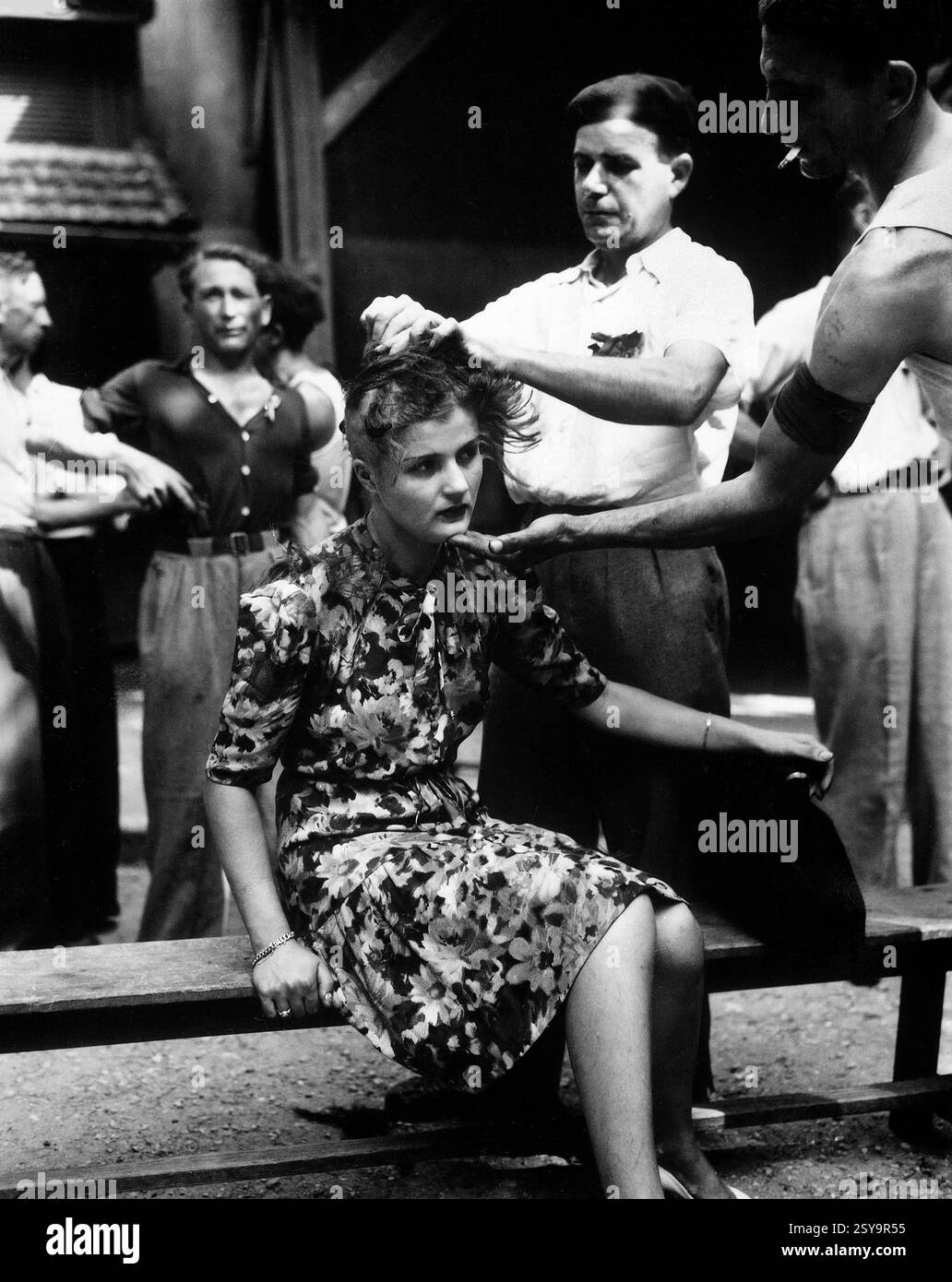 French civilians shaving woman's head as punishment for having personal ...