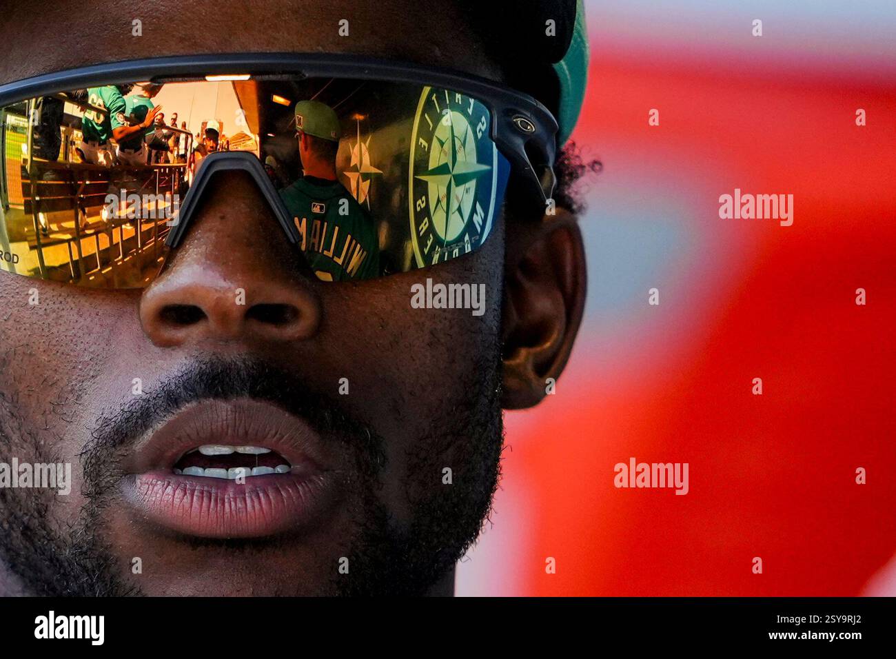 Seattle Mariners second baseman Ryan Bliss walks in the dugout before a ...