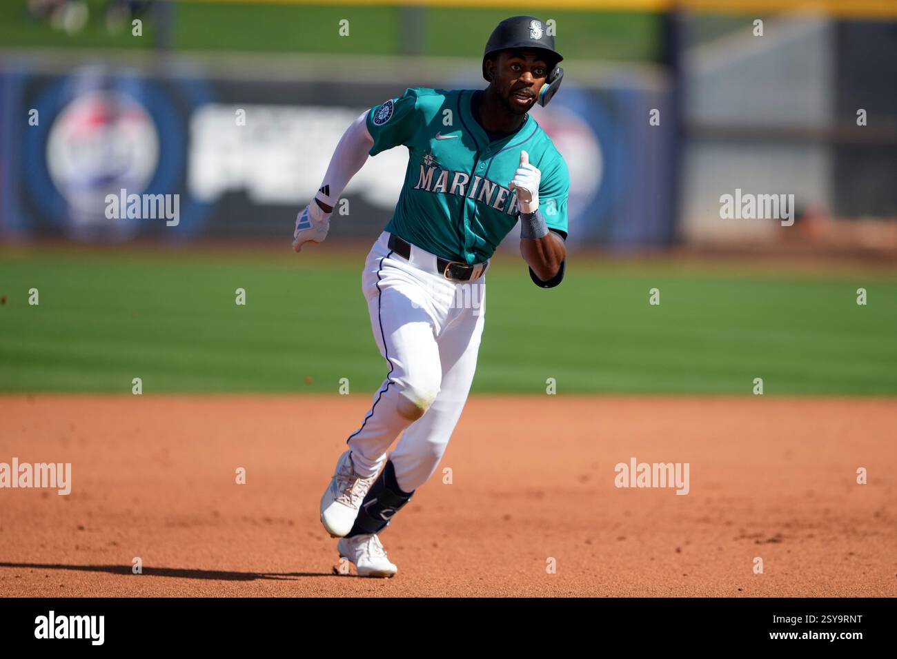 Seattle Mariners' Ryan Bliss runs to third on an RBI triple to score ...