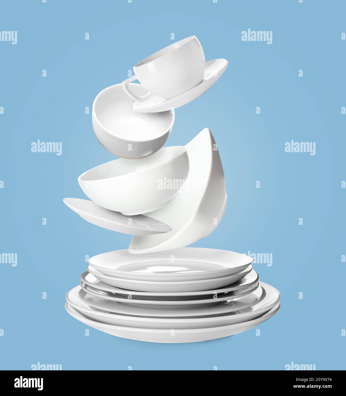 Clean dishware flying over plates on pastel blue background Stock Photo ...