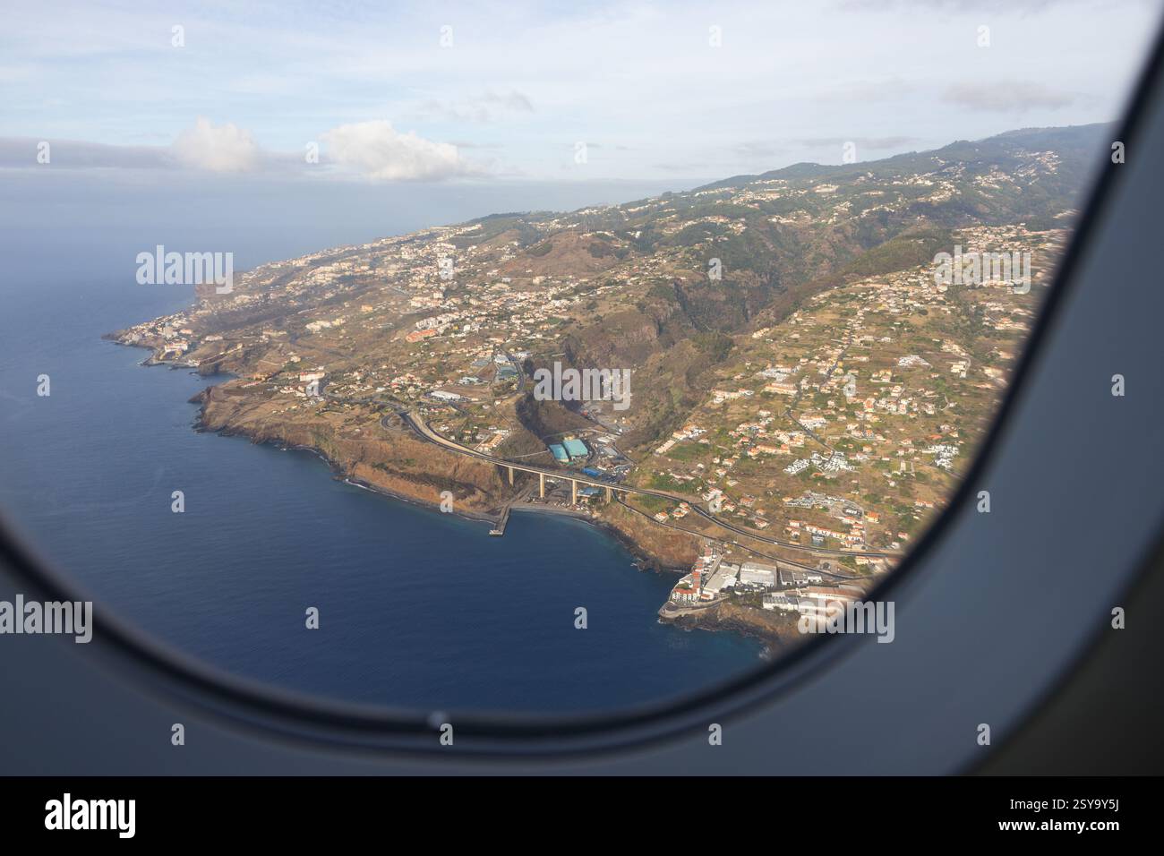 View from the window of an airplane to Madeira's island shore. Madeira ...