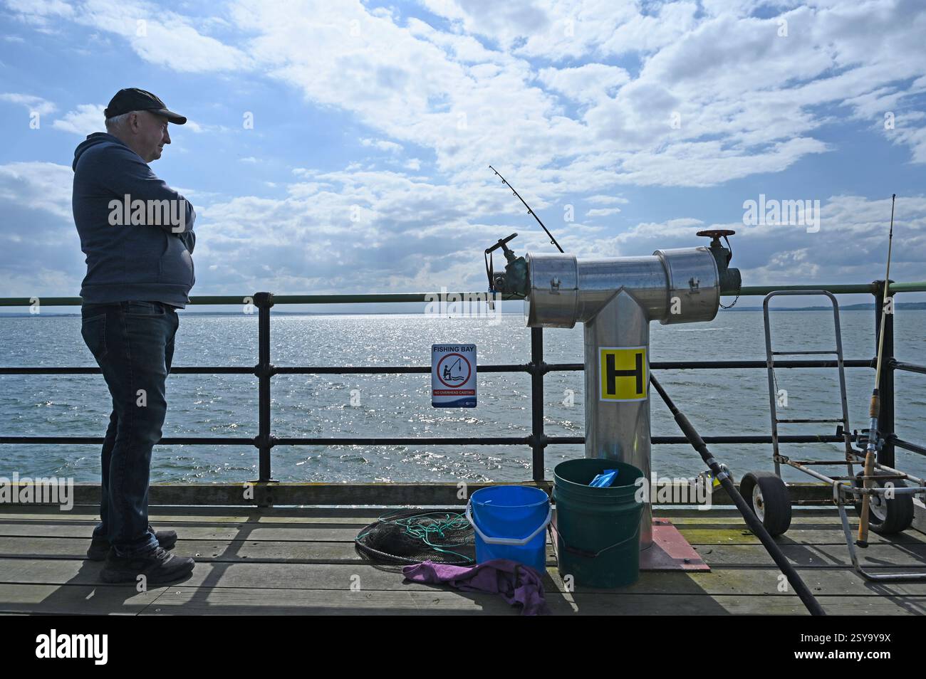 A man patiently waiting for a catch, fishing from the longest pleasure ...
