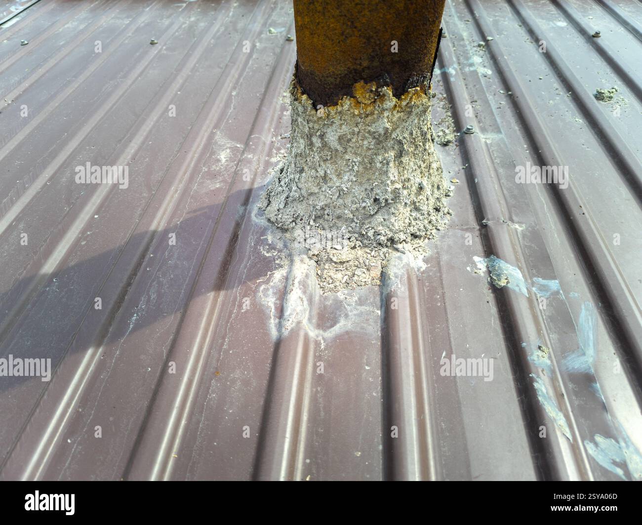 steel stove pipe connection on a metal roof with signs of rust and poor ...