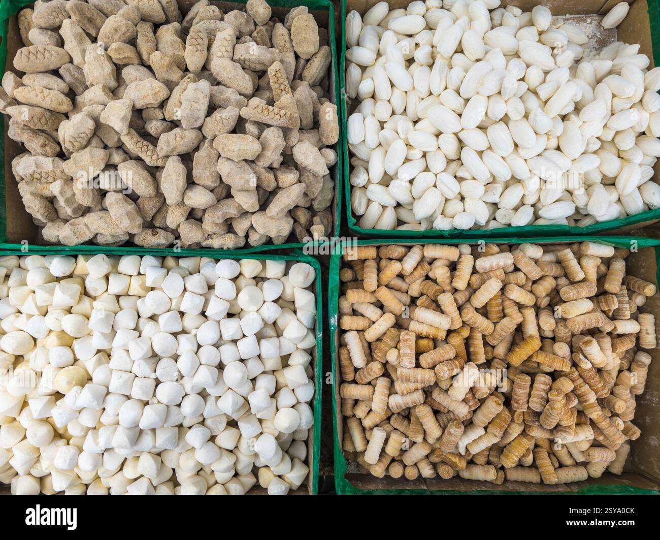 Different types of qurut in boxes on the counter of an Asian market ...