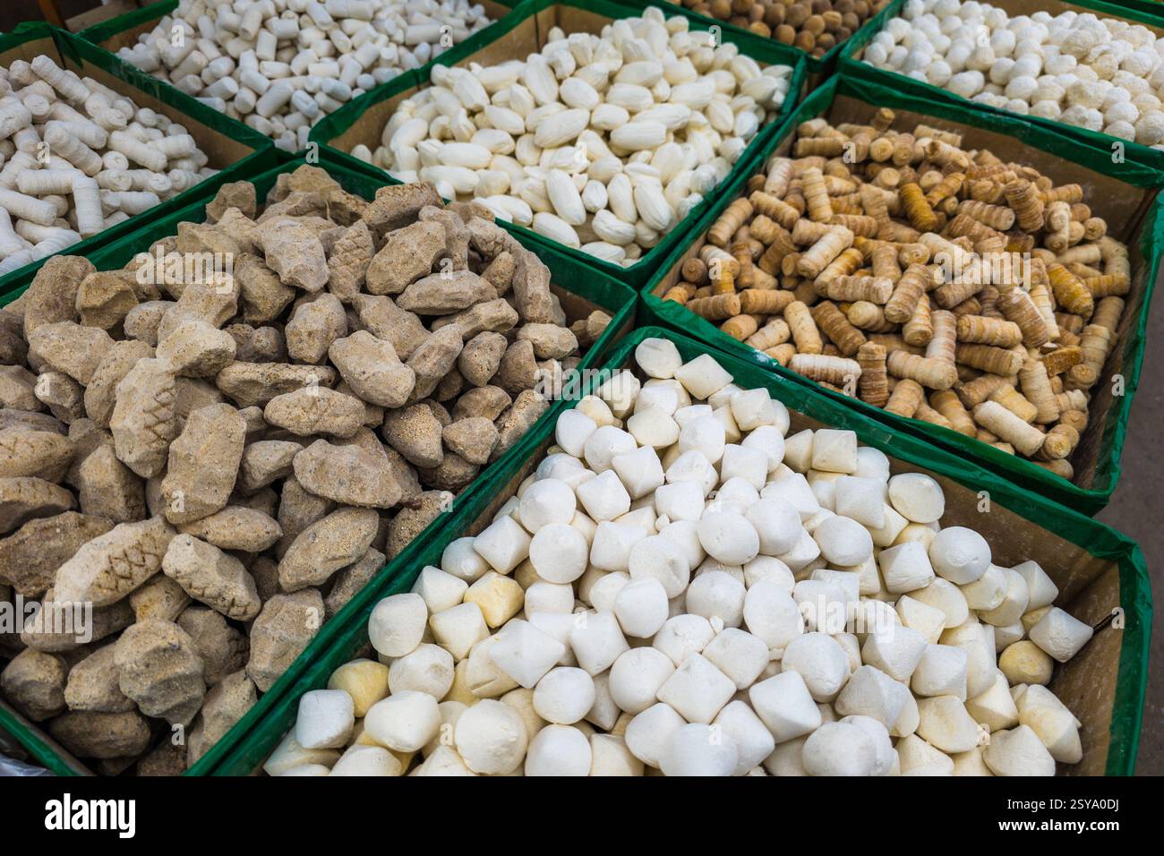 Different types of qurut in boxes on the counter of an Asian market ...