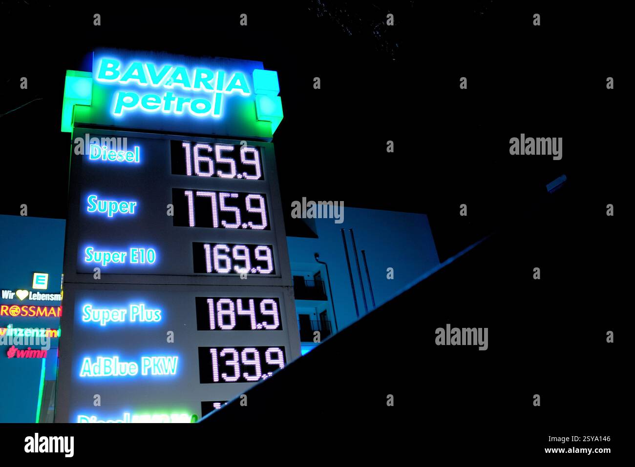 Illuminated Bavaria Petrol sign at night with prices for fuel in early ...