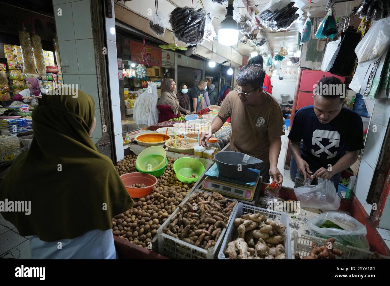 Indonesian women buy condiment as they prepare for the holy month of ...