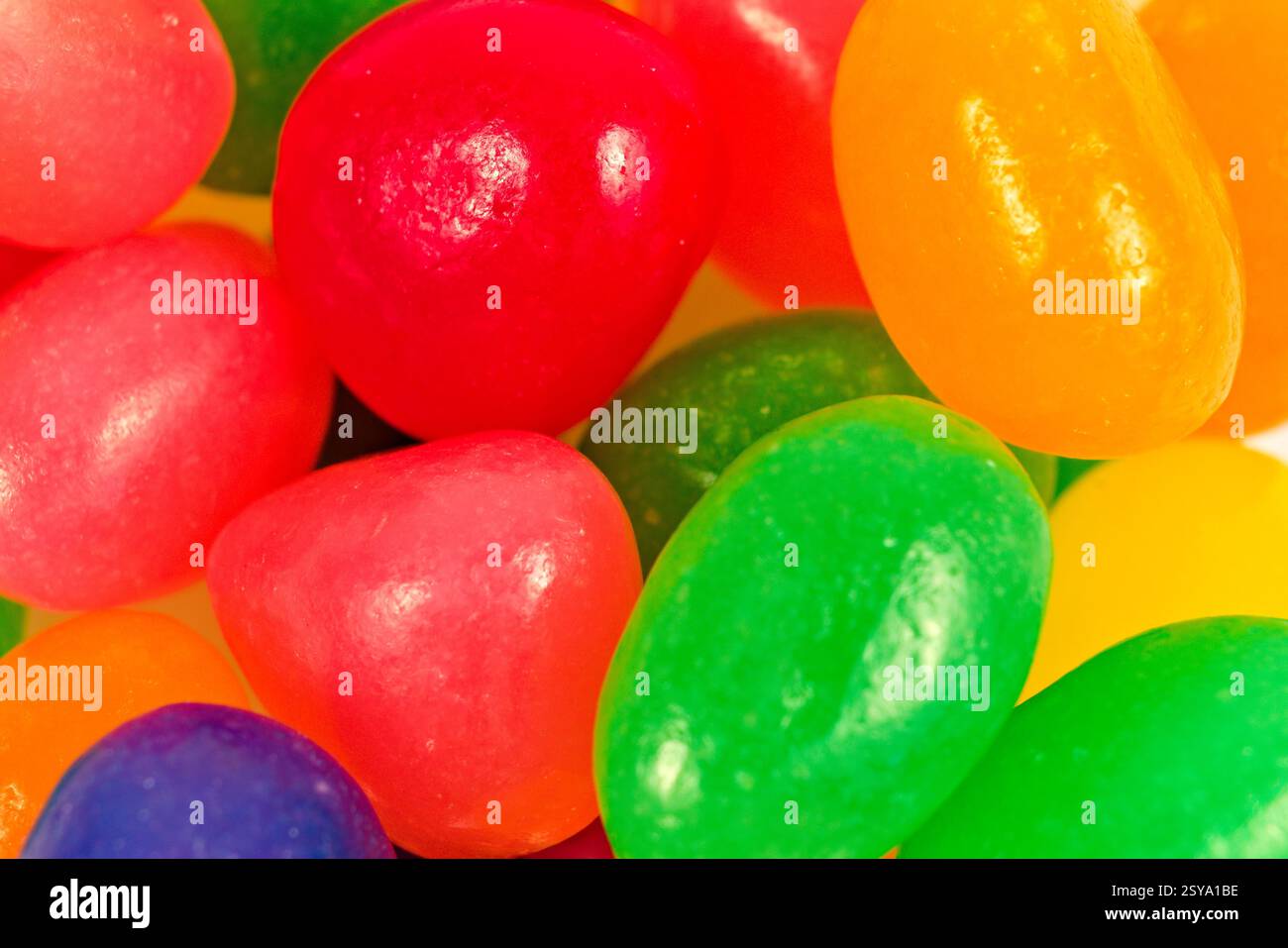 A close up shot of multiple colored jelly beans on a table Stock Photo ...
