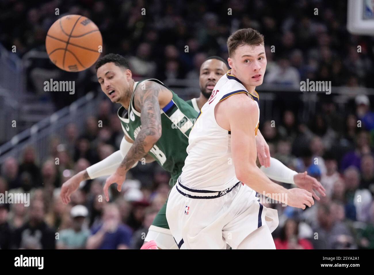 Denver Nuggets' Christian Braun and Milwaukee Bucks' Kyle Kuzma go ...