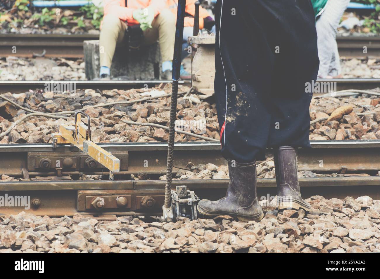 Railway employees working for restoration the railroad tracks in ...