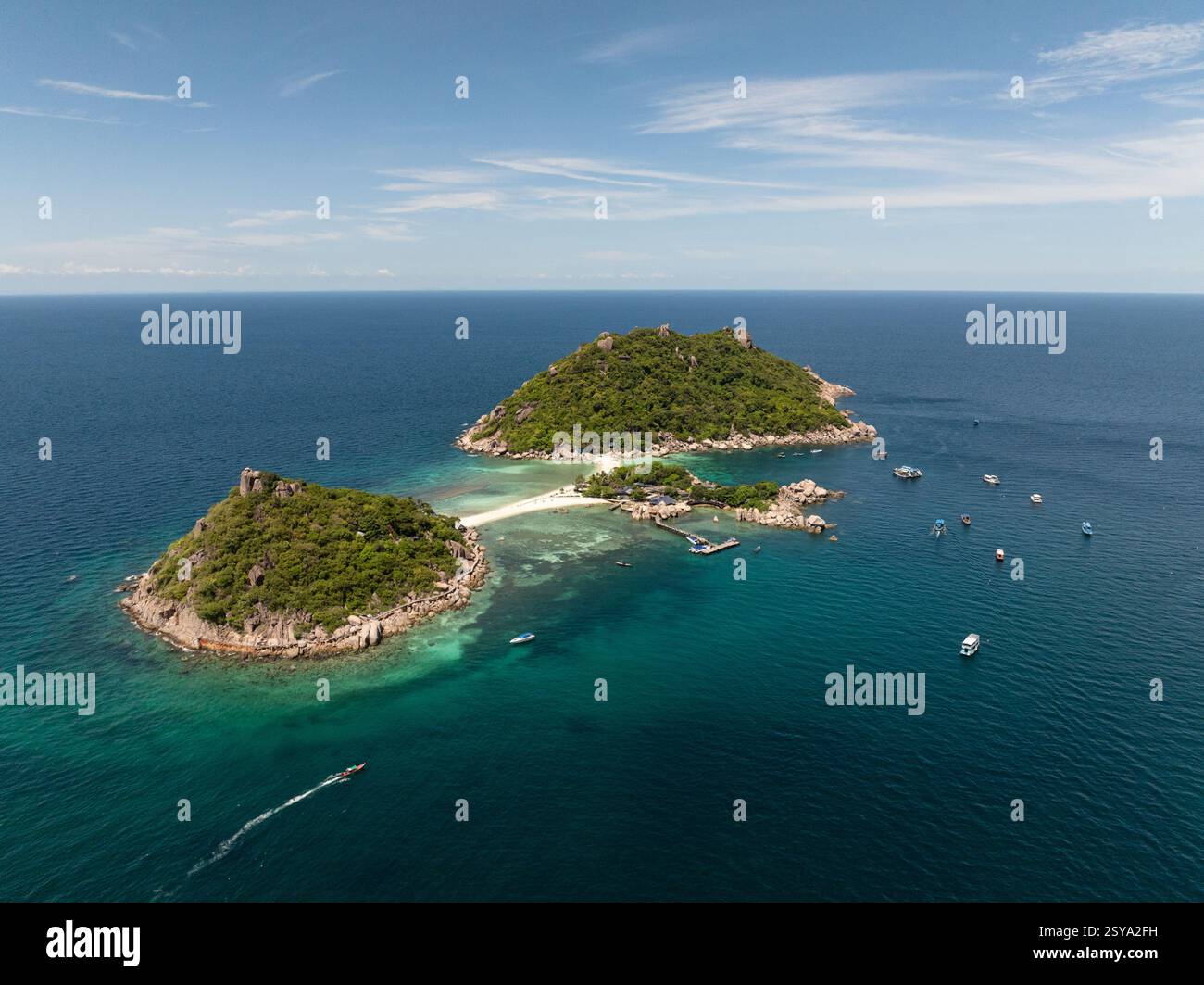Aerial view of tropical island connected by a sandbar with boats ...