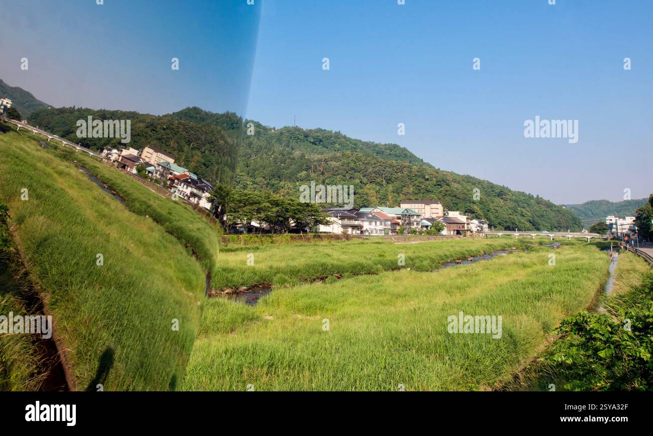 The early morning sun tinges the inns and bath houses at the hot spring ...