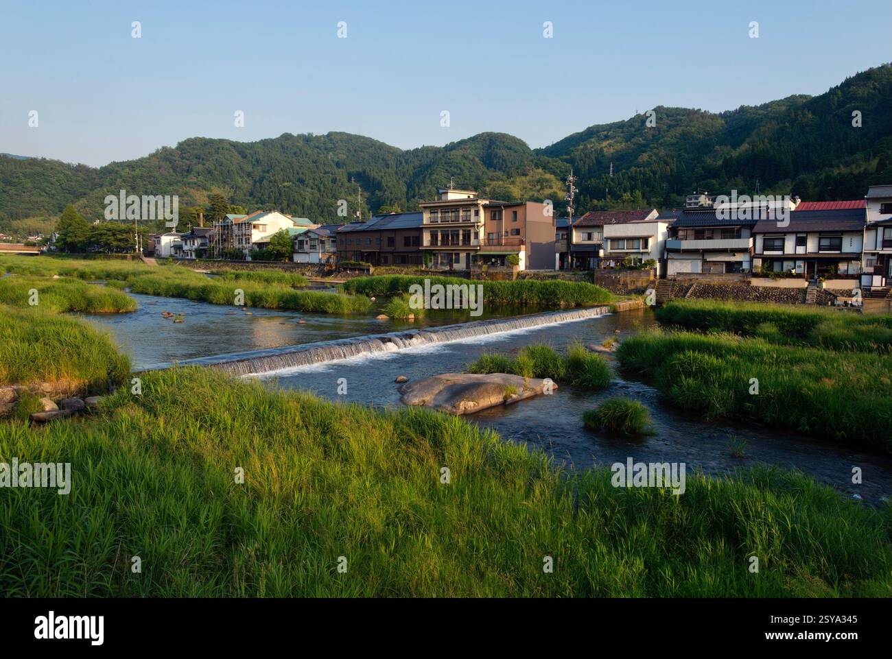 The early morning sun tinges the inns and bath houses at the hot spring ...