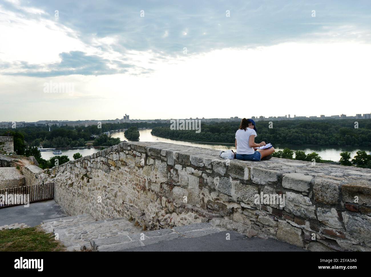 A tourist enjoying the view of the confluence of the Sava and Danube ...