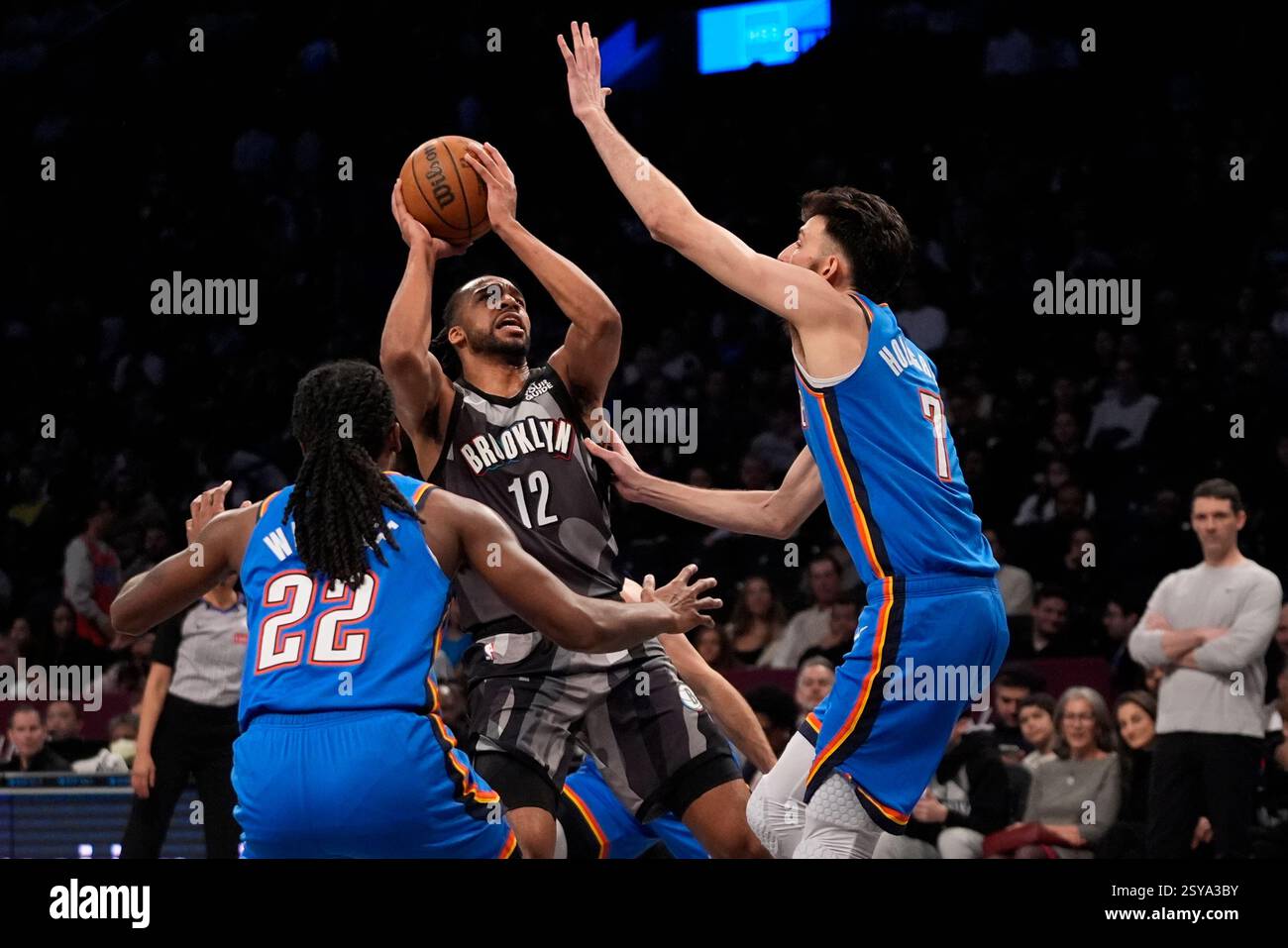 Brooklyn Nets' Tosan Evbuomwan (12) shoots over Oklahoma City Thunder's ...