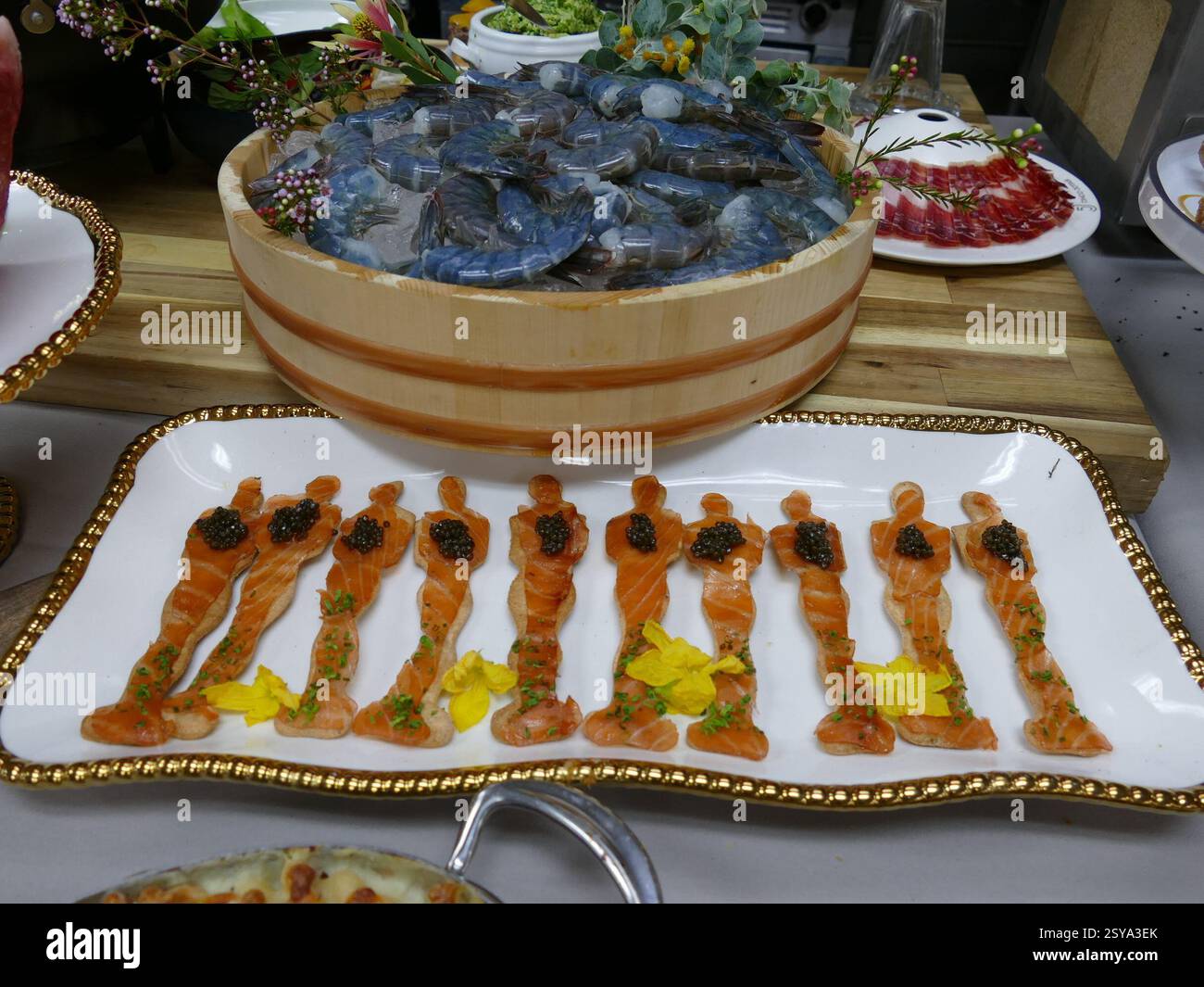 Los Angeles, USA. 27th Feb, 2025. Strips of wild salmon are cut into ...