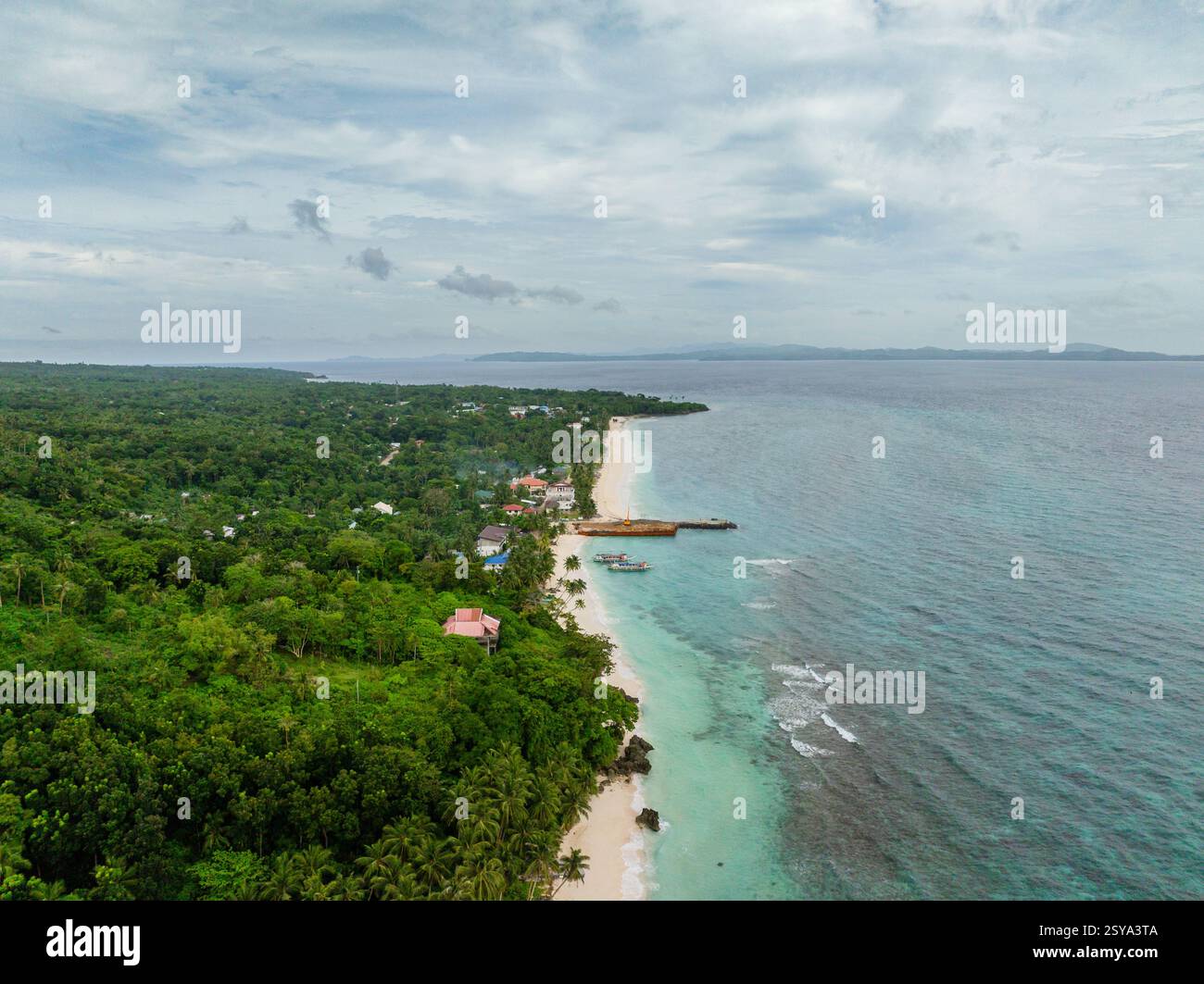 White sand beach with crystal clear ocean waves. Poblacion San Jose in ...