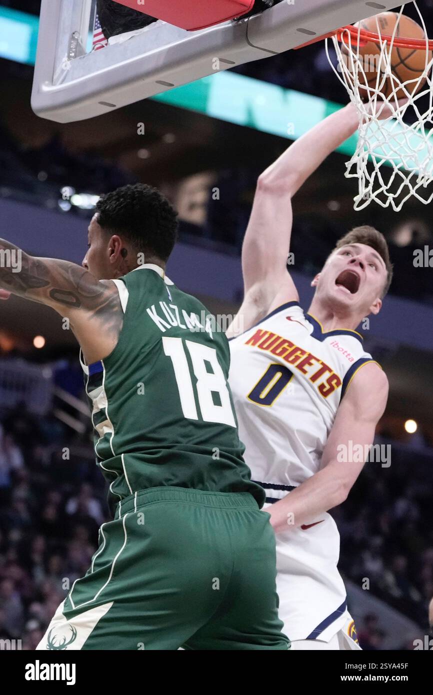 Denver Nuggets' Christian Braun shoots past Milwaukee Bucks' Kyle Kuzma ...